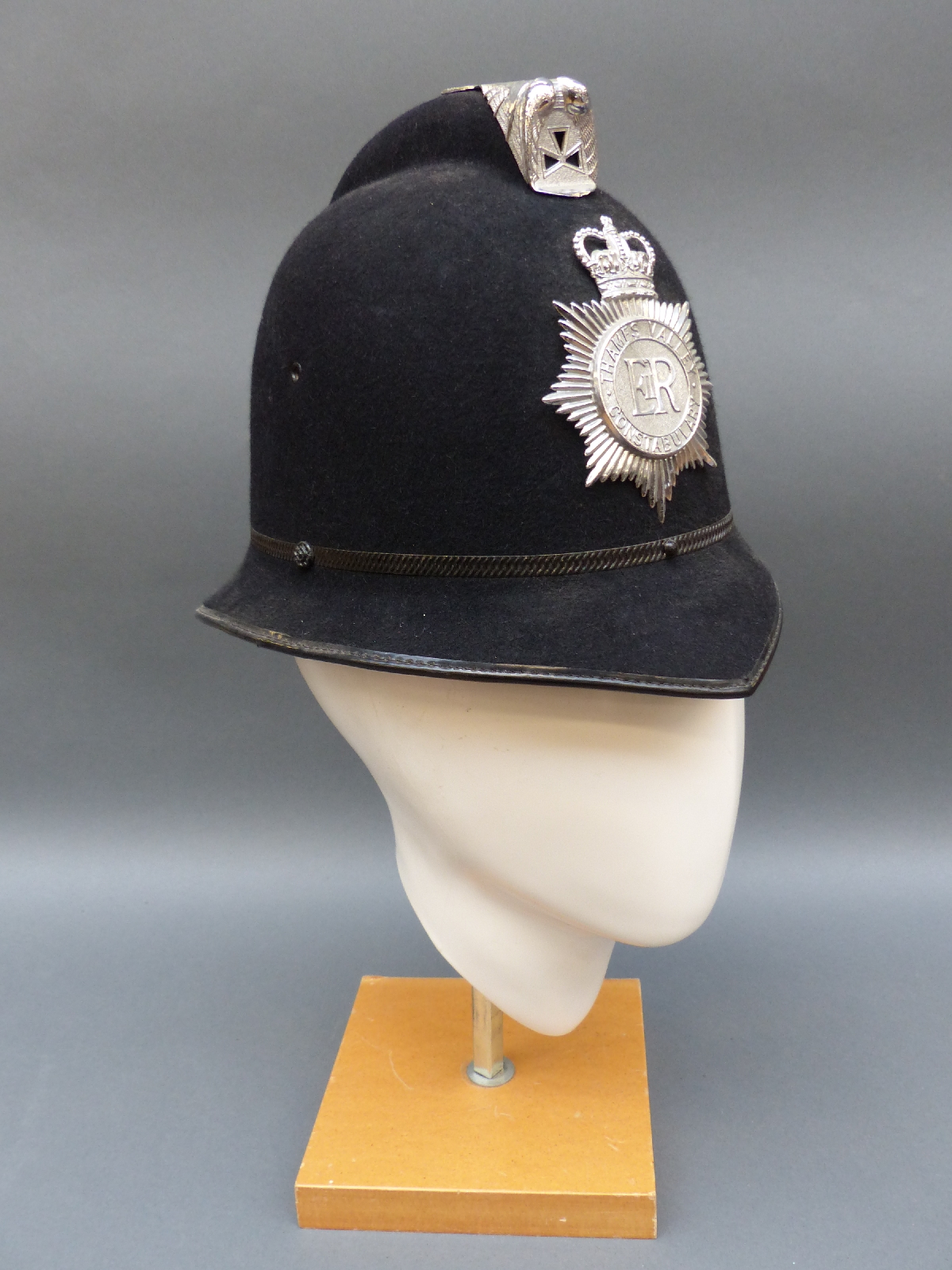 Three vintage police helmets including Thames Valley, Reading and Berkshire