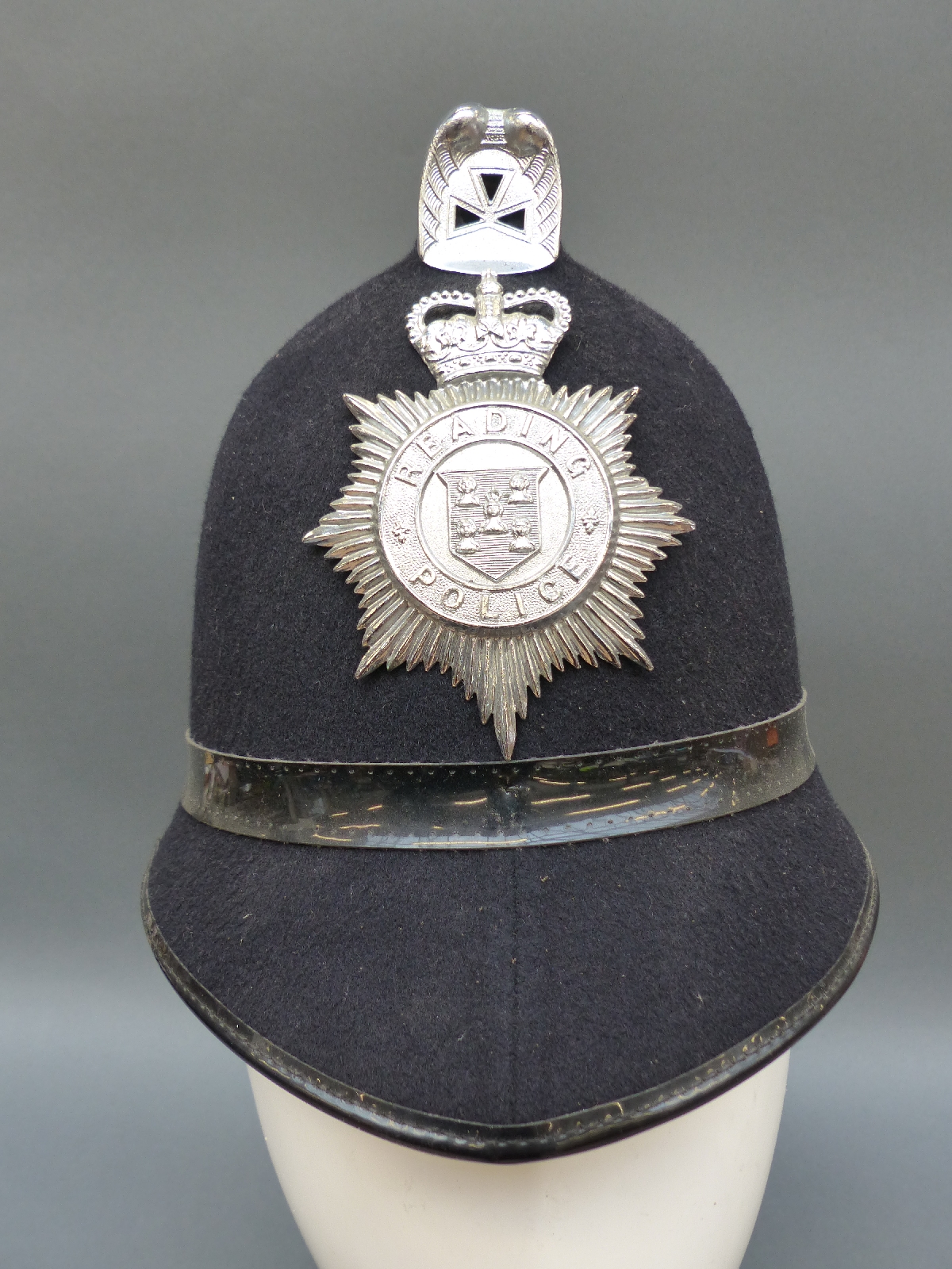 Three vintage police helmets including Thames Valley, Reading and Berkshire