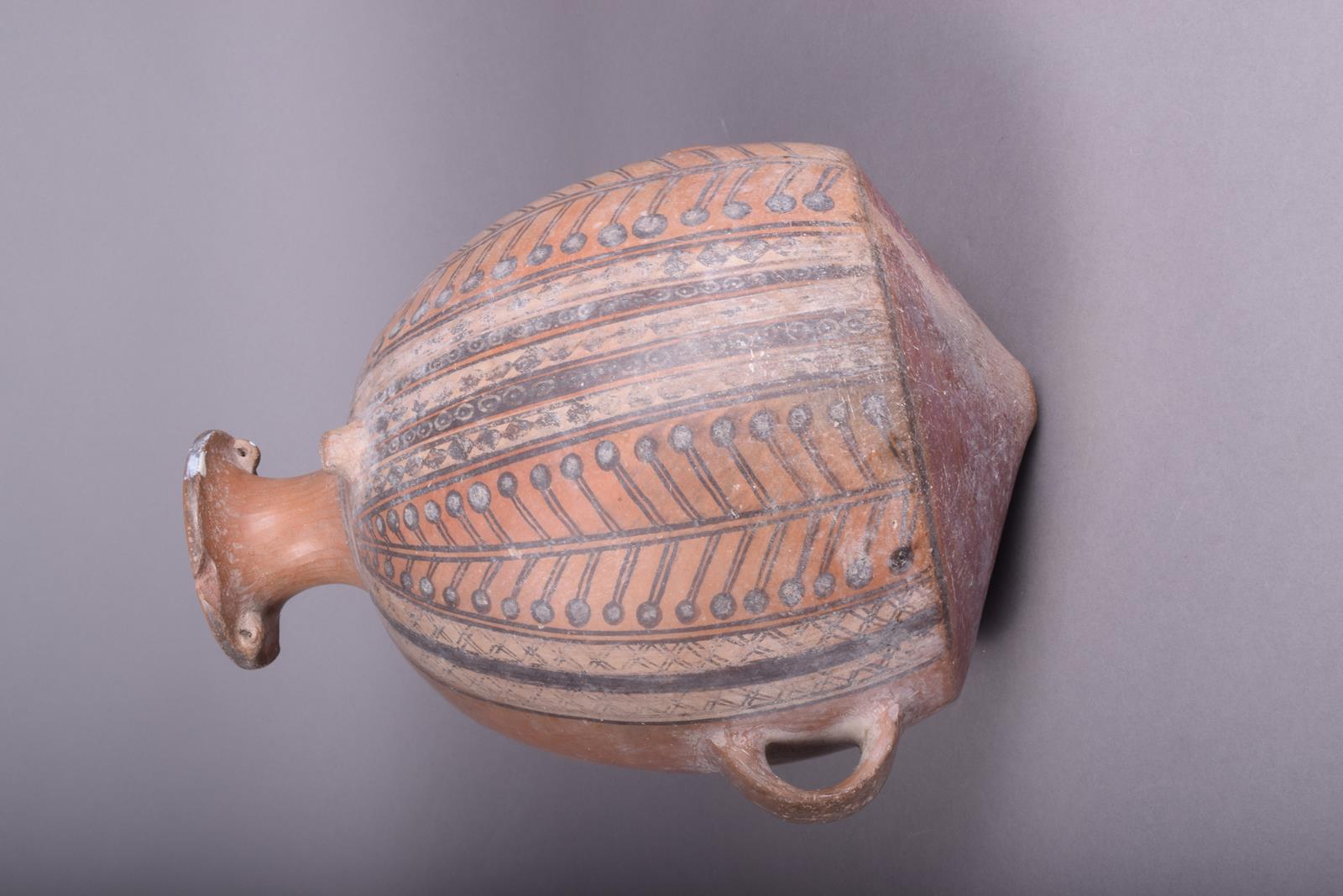 An Inca pottery urpu, storage jar, with a conical base and ovoid body ...