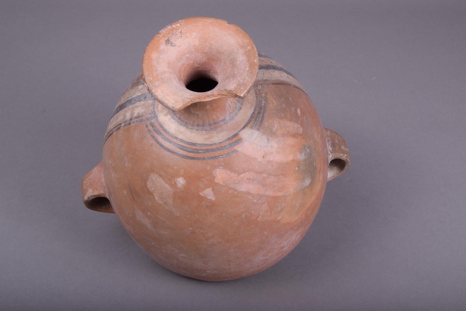 An Inca pottery urpu, storage jar, with a conical base and ovoid body ...