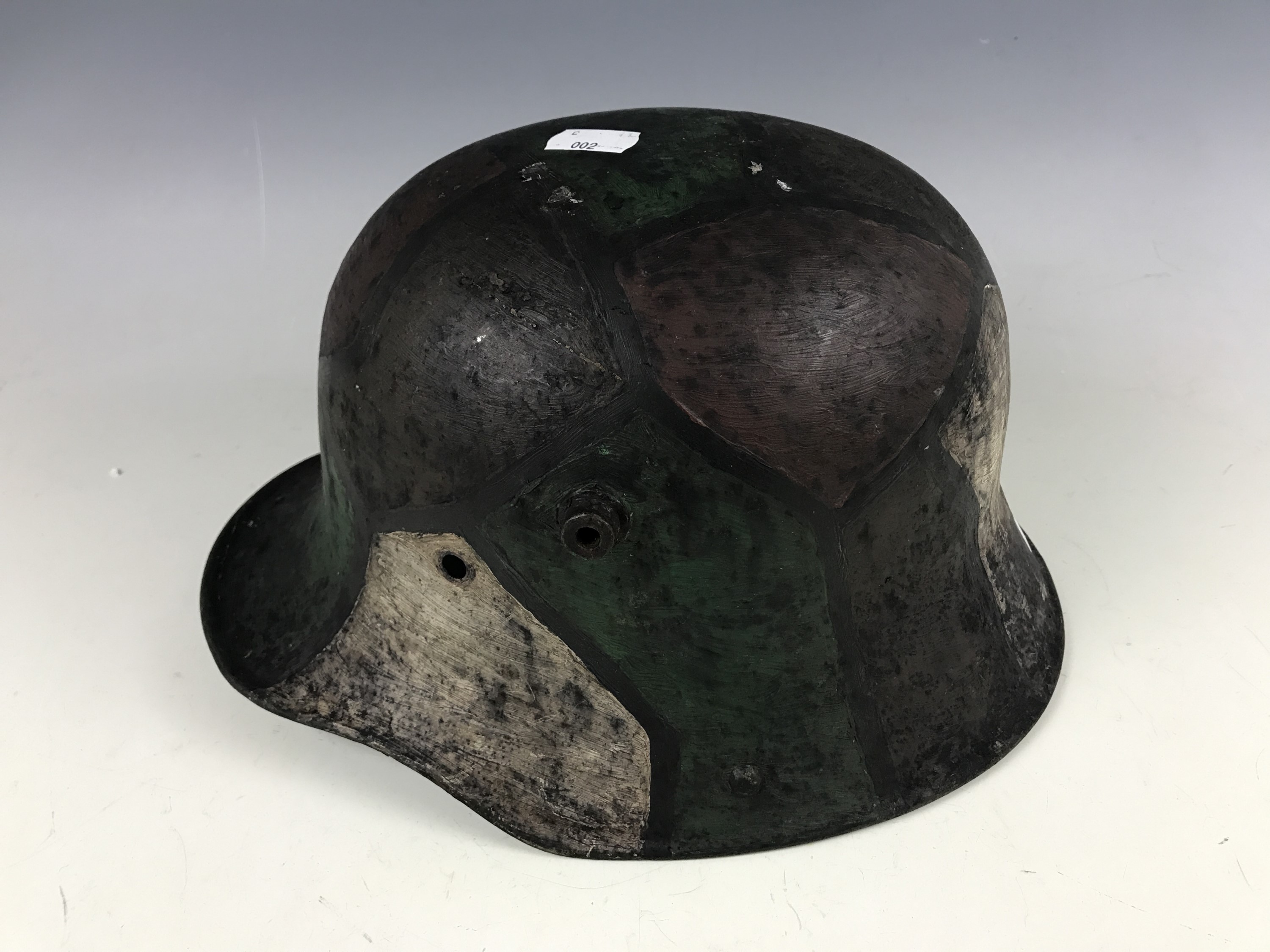 A First World War German steel helmet, with original liner and later ...