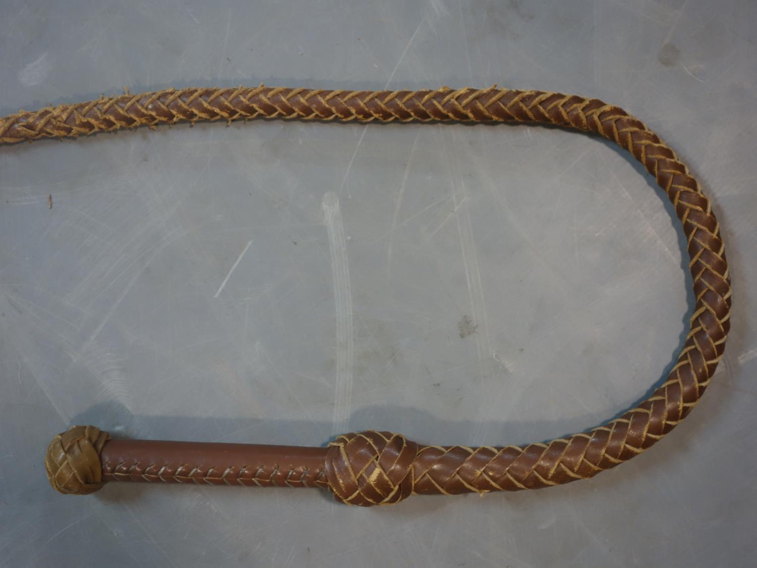 A vintage 8ft brown leather bull whip