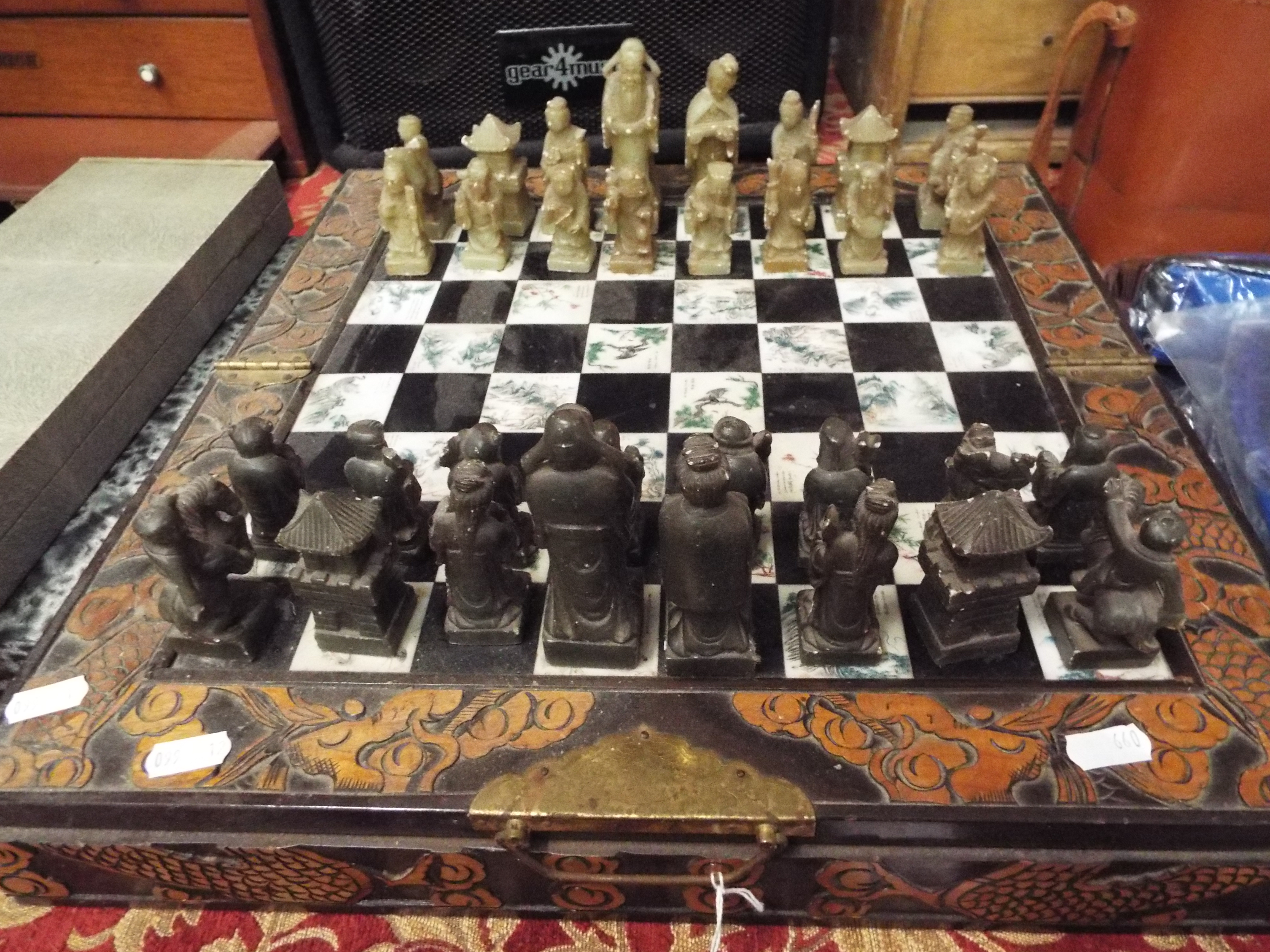 An ornate Chinese chess set with faux jade pieces the carved board ...