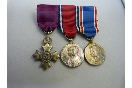 OBE Medals in boxes with OBE certificates