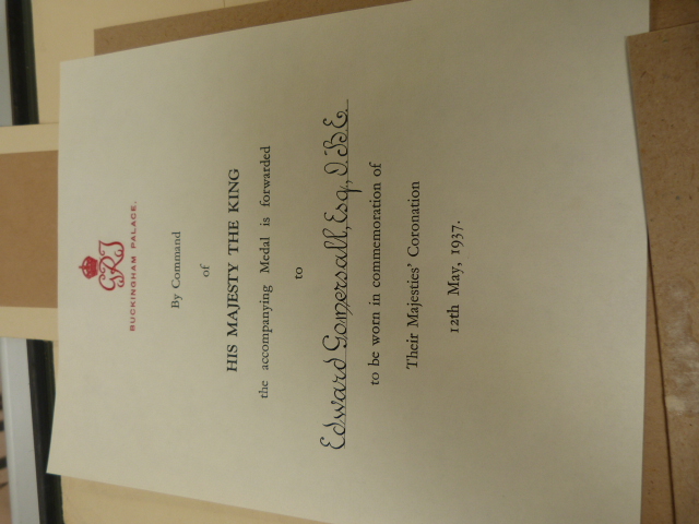 OBE Medals in boxes with OBE certificates