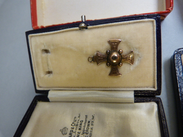 OBE Medals in boxes with OBE certificates