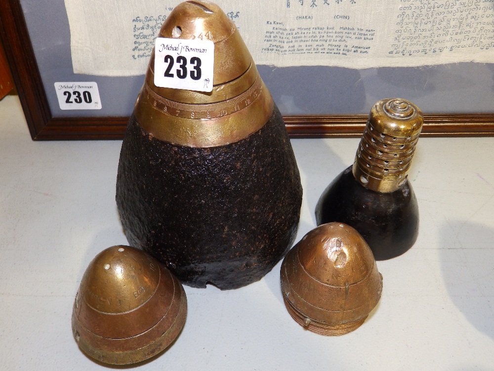 A French WWI beehive fuse, a British 18 pounder shrapnel shell together ...
