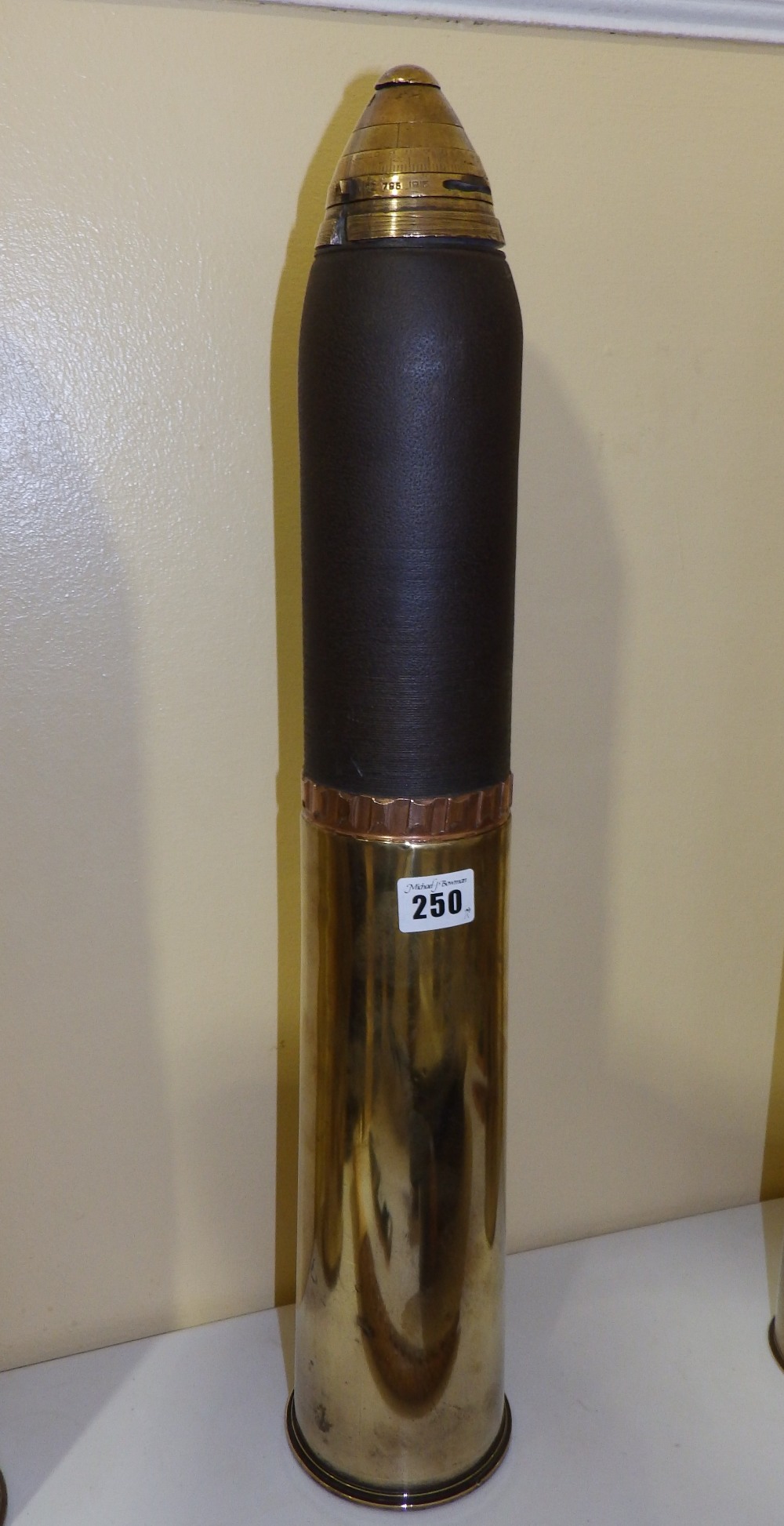 A British WWI 18 pounder shrapnel shell and case, the fuse dated 1915 ...