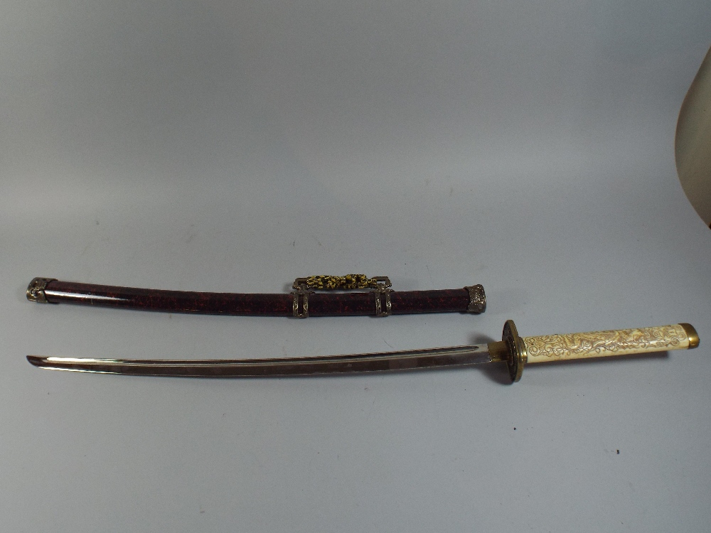 A Reproduction Katana Sword with Faux Ivory Handle.
