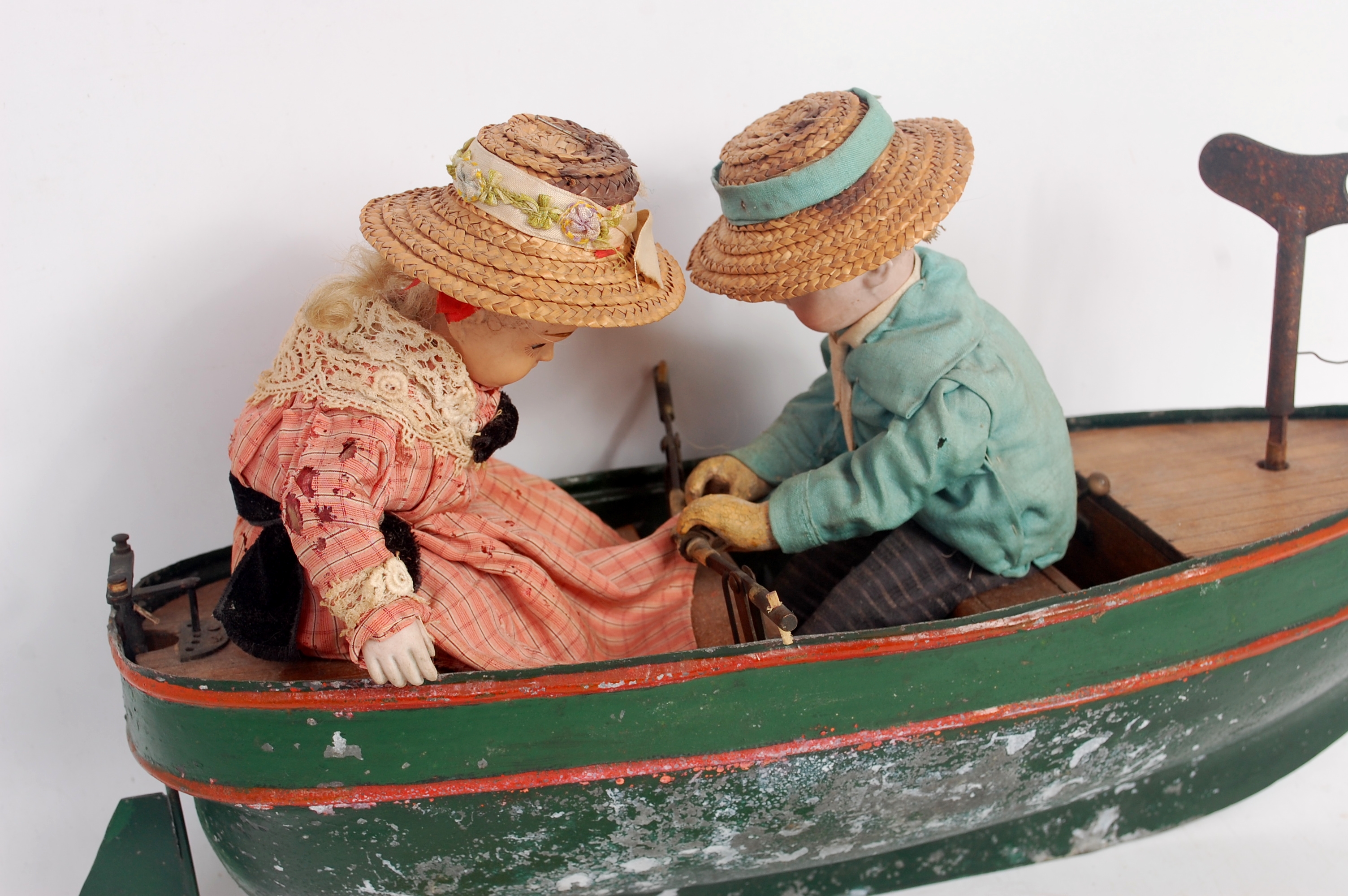 An early 20th century clockwork rowing boat toy, comprising metal ...