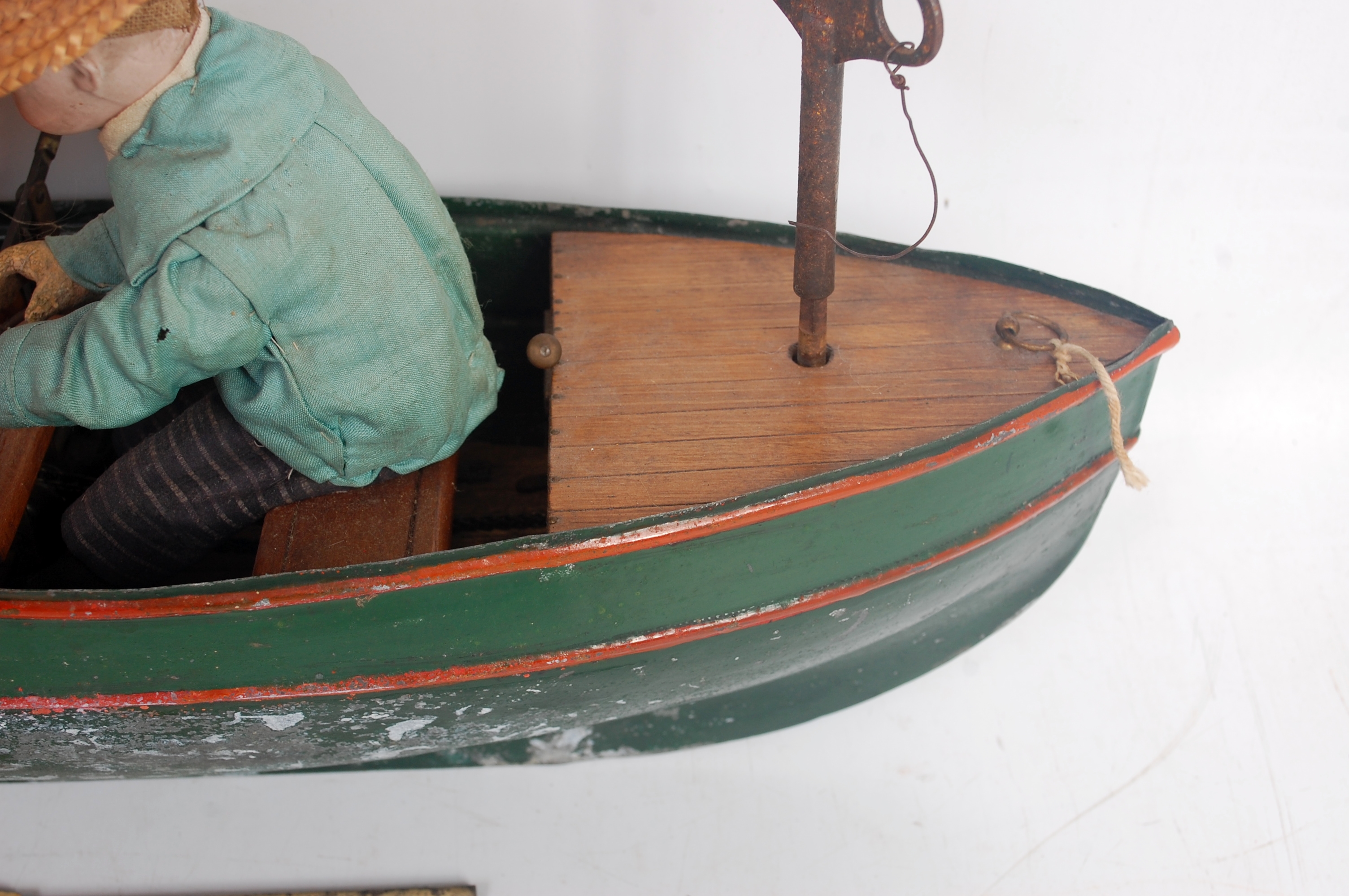 An early 20th century clockwork rowing boat toy, comprising metal ...