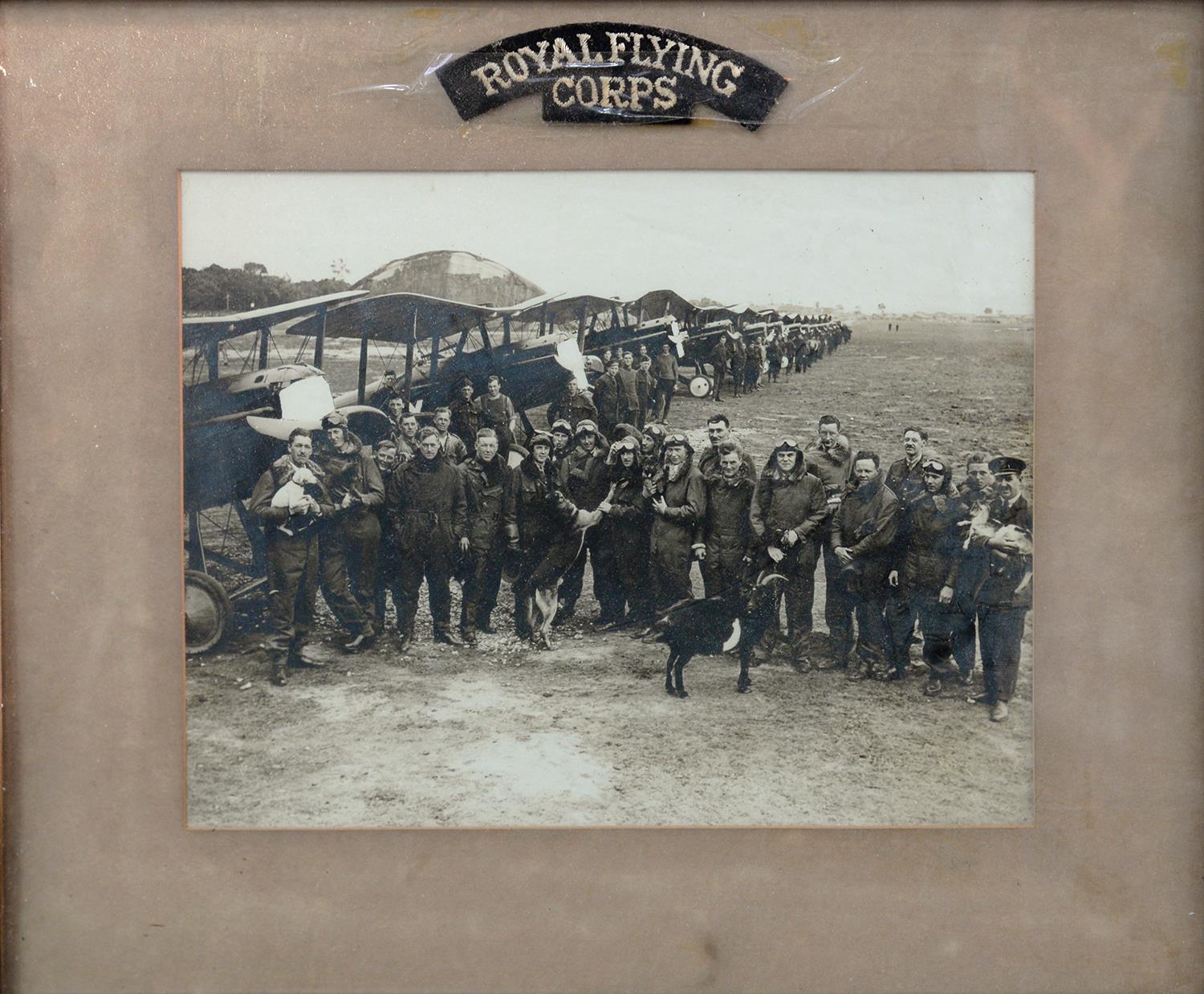 ROYAL FLYING CORPS. A PHOTOGRAPH OF PILOTS AND THEIR MASCOT STANDING ...