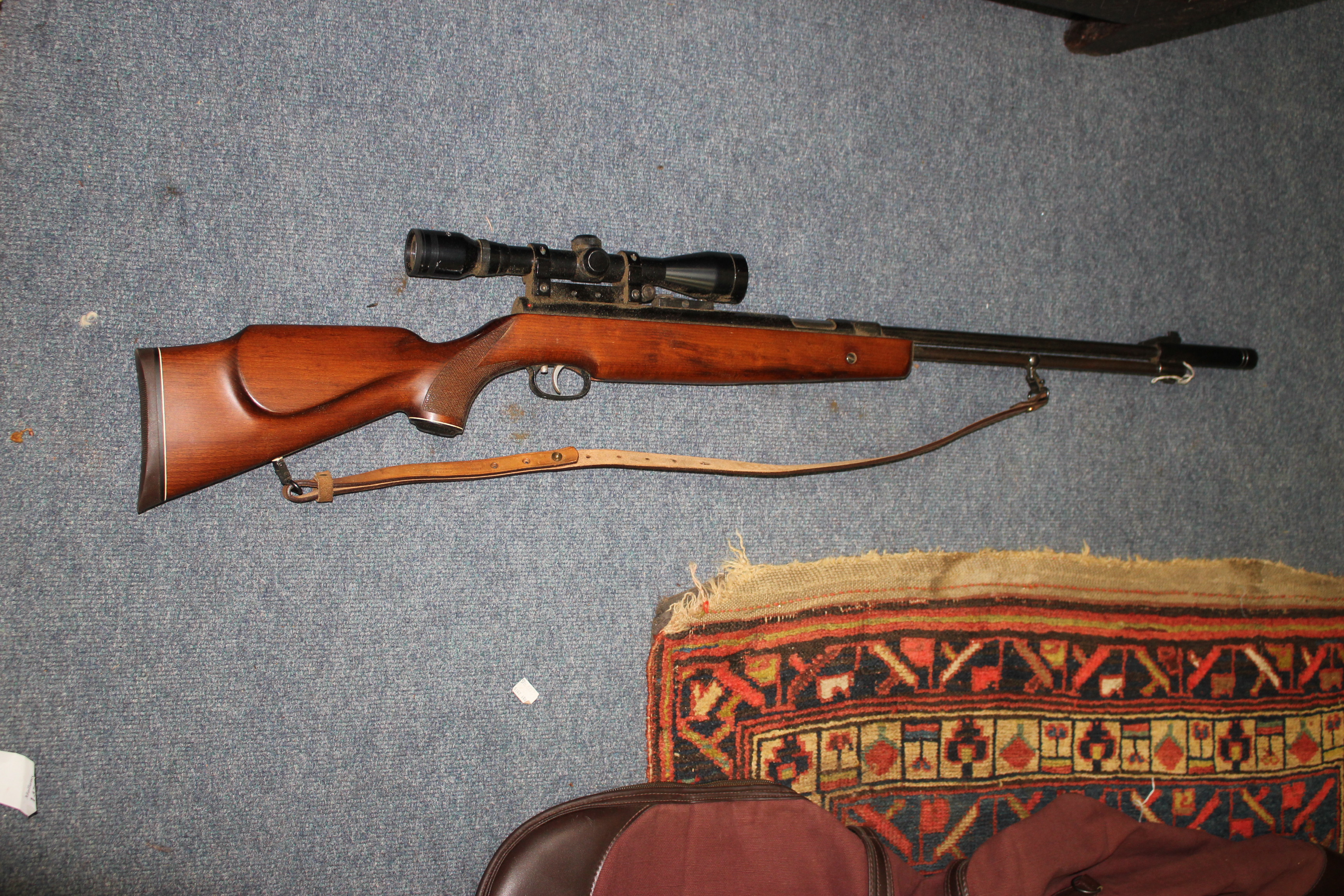 A WEIHRAUCH WEST GERMAN HW77 AIR RIFLE mounted with a Tasco scope