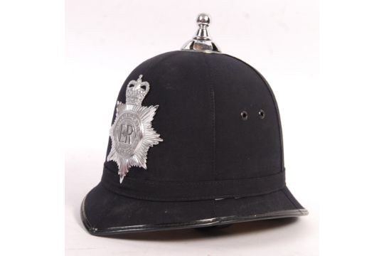 A 20th century Humberside Police officer's uniform helmet. Retains the ...