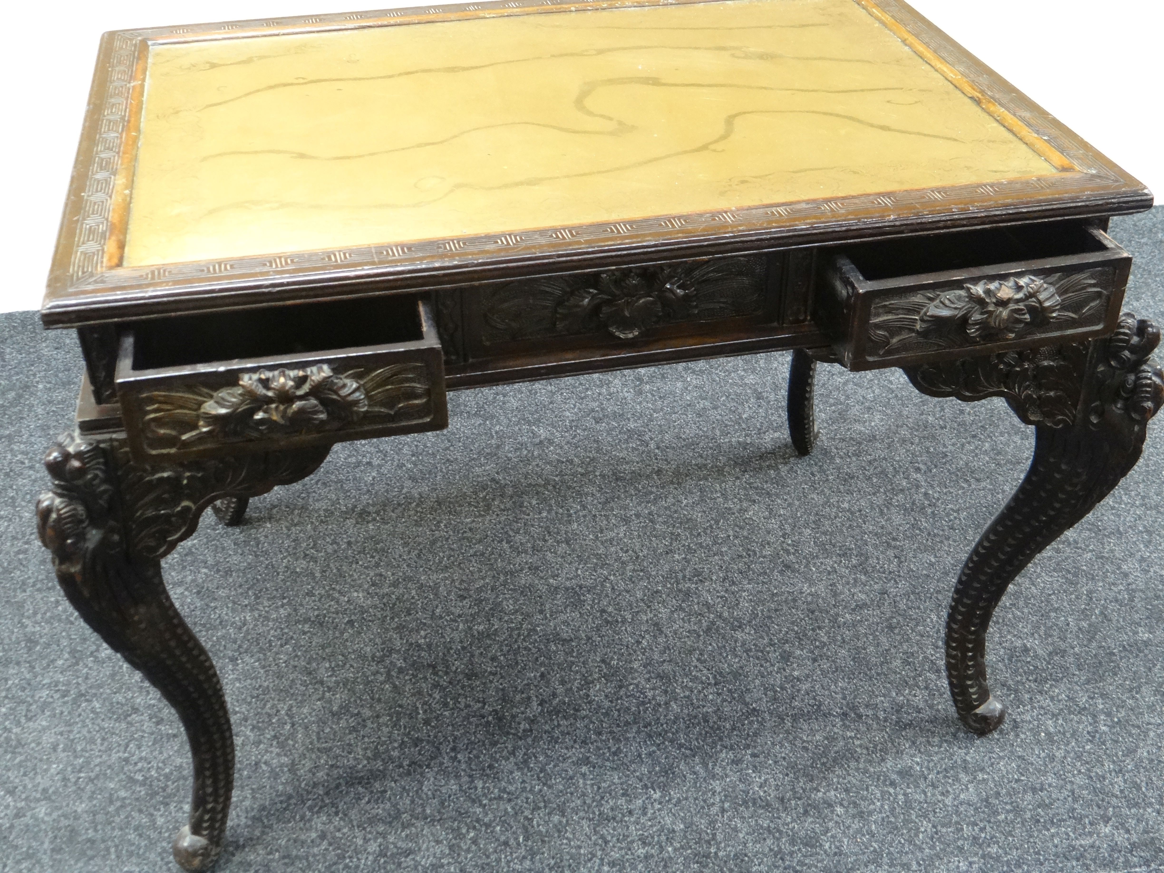 AN UNUSUAL CHINESE CARVED TABLE with inset brass top, the brass ...