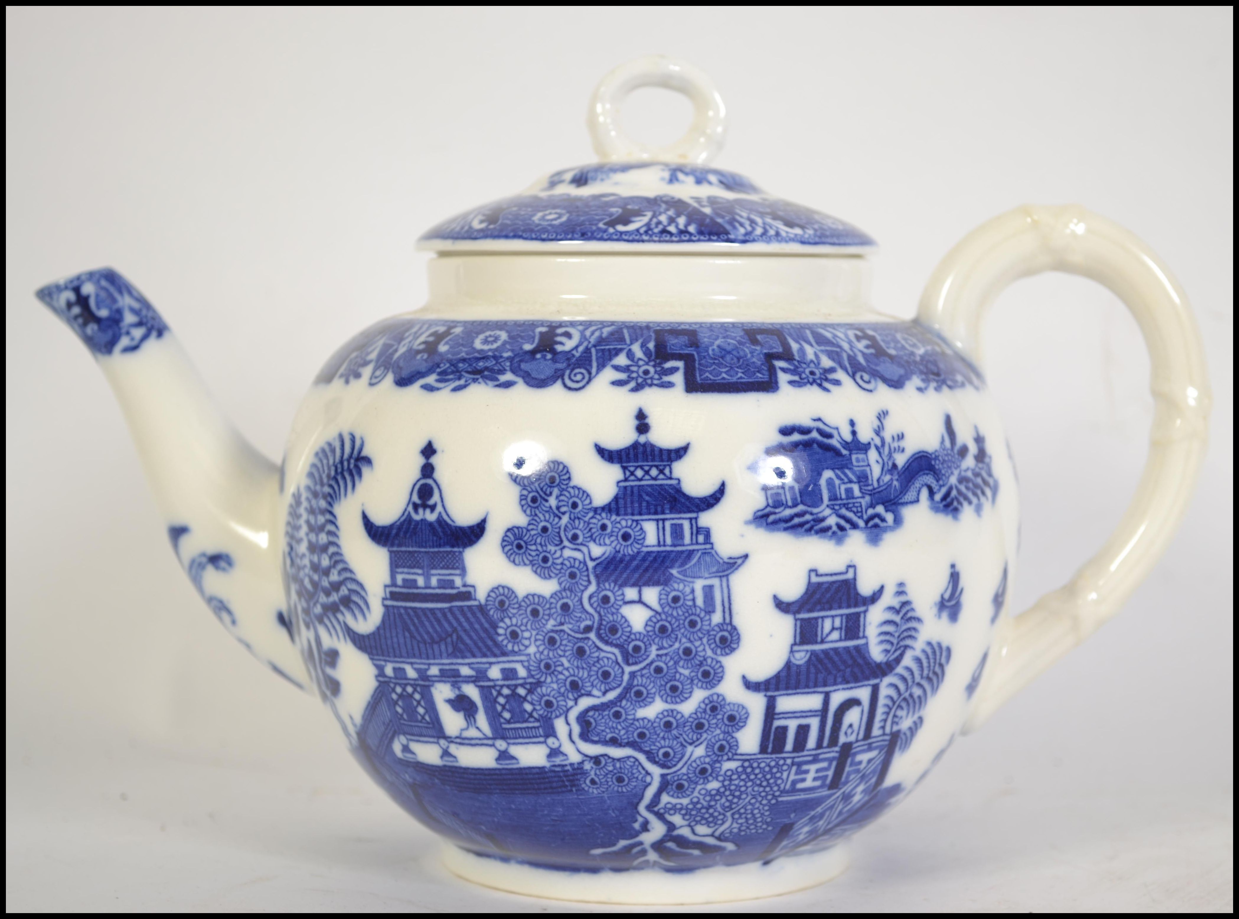 A Royal Worcester blue and white porcelain teapot in the ' Willow ...