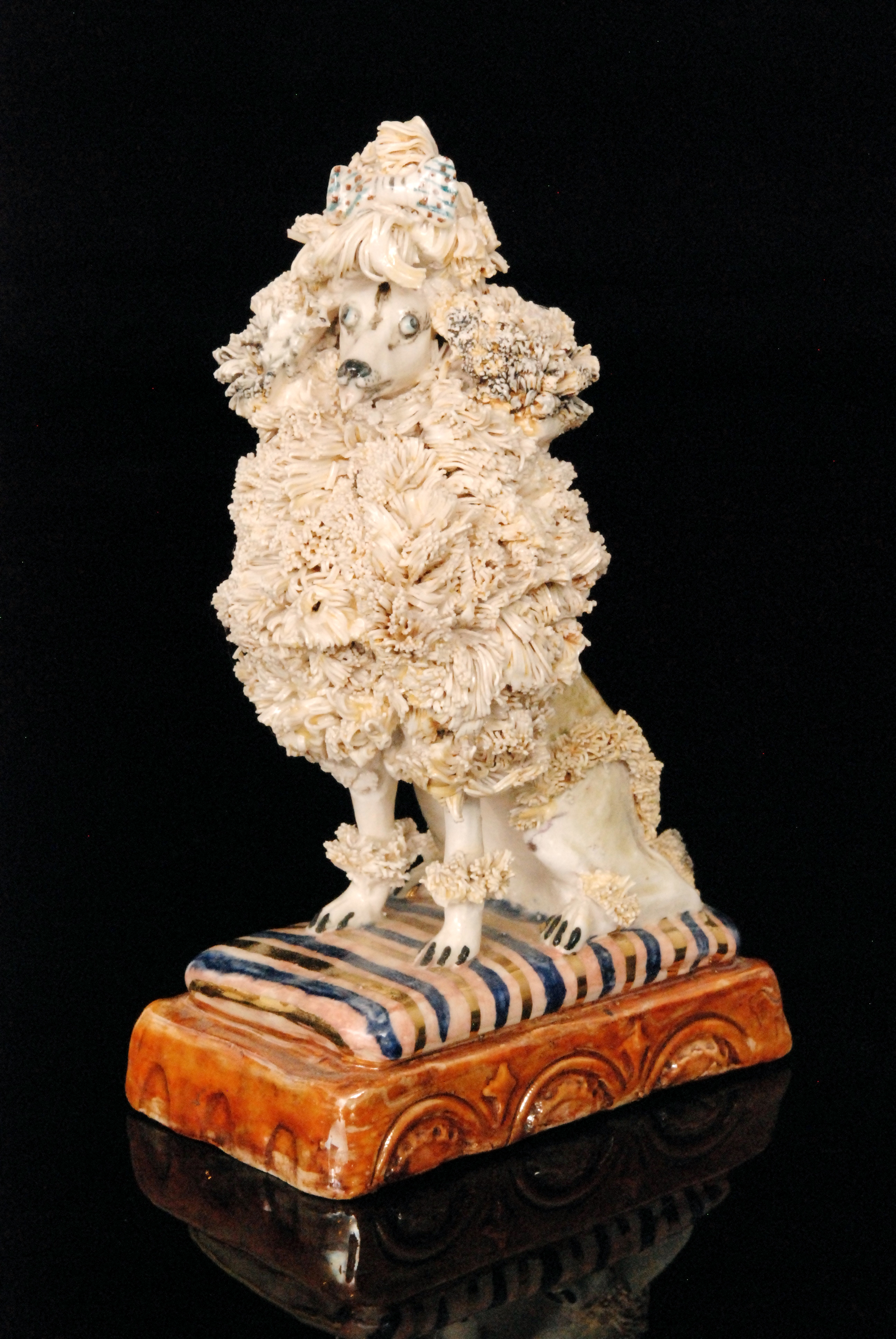 A Basil Matthews studio pottery model of a seated poodle entitled ...