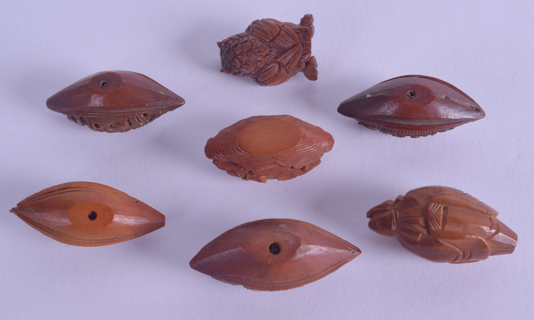 A GROUP OF SIX 19TH CENTURY CHINESE CARVED NUTS together with a carved ...