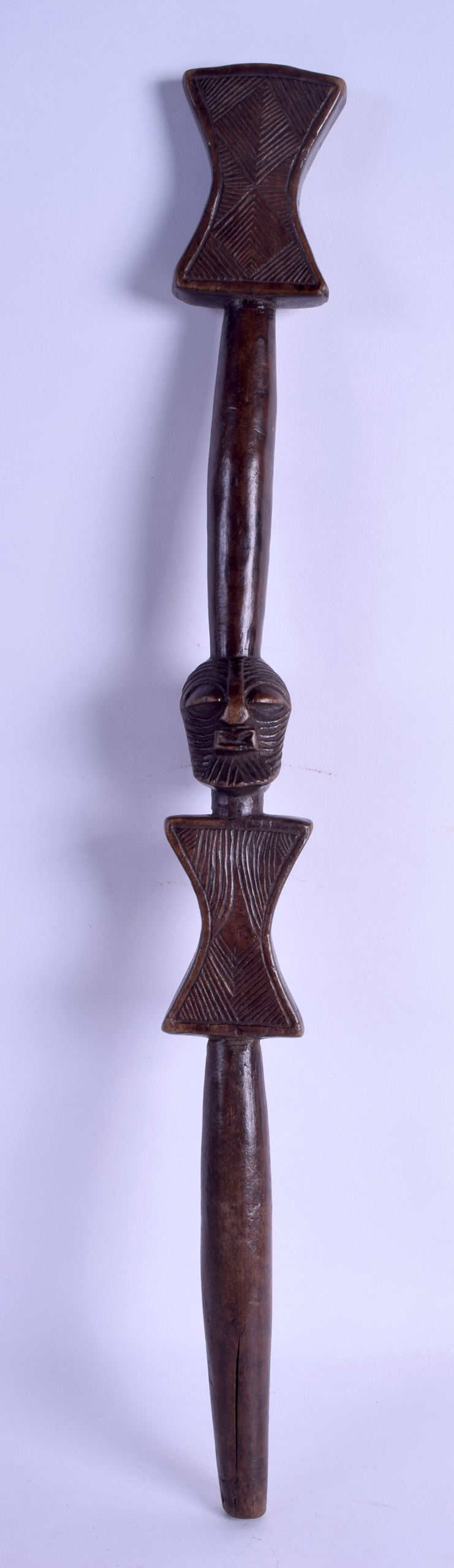 AN AFRICAN TRIBAL HARDWOOD CARVED CEREMONIAL STAFF formed with opposing ...