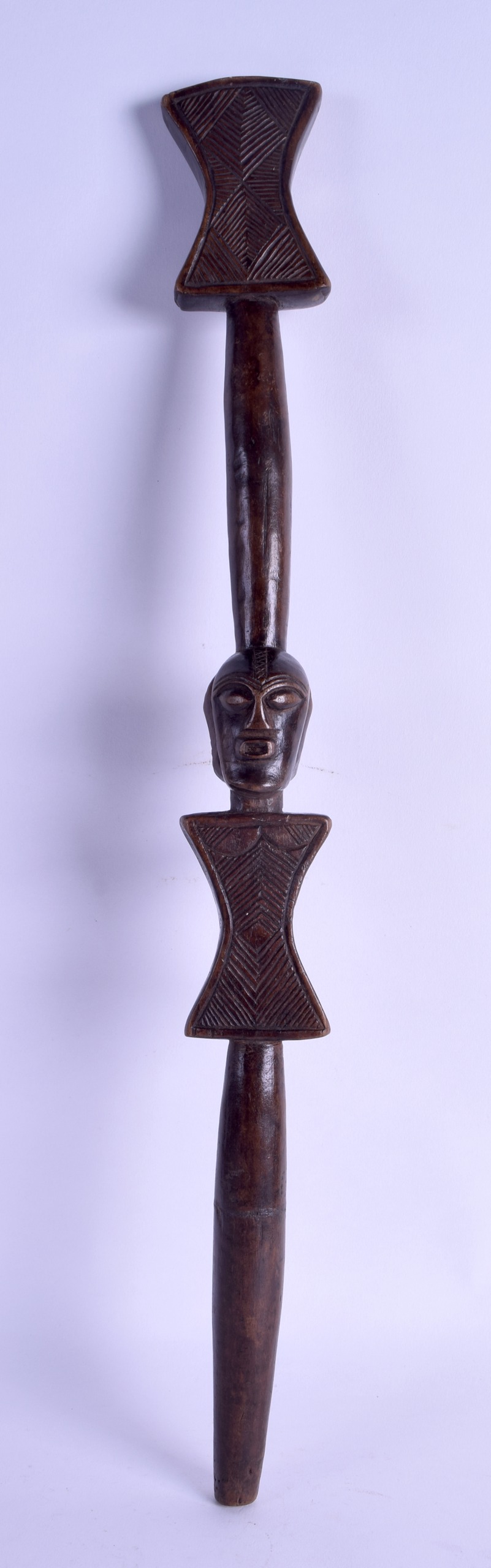 AN AFRICAN TRIBAL HARDWOOD CARVED CEREMONIAL STAFF formed with opposing ...