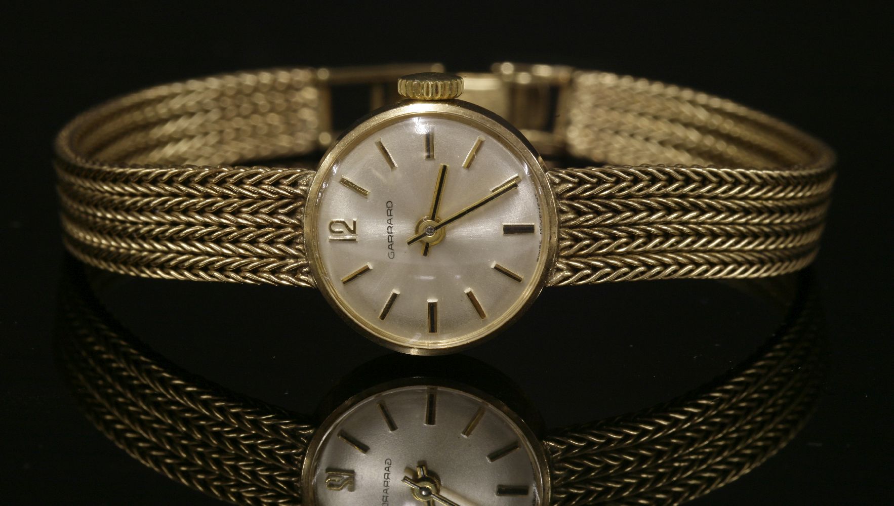 A ladies 9ct gold Garrard mechanical bracelet watch,with a circular ...