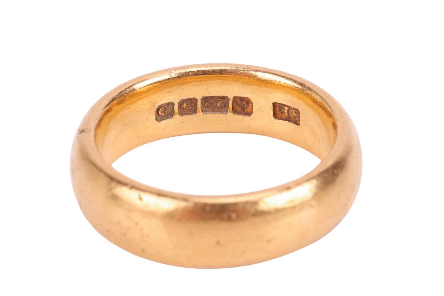 A 22ct court-style wedding band measuring 5.1 mm wide, size G, 7.2 ...