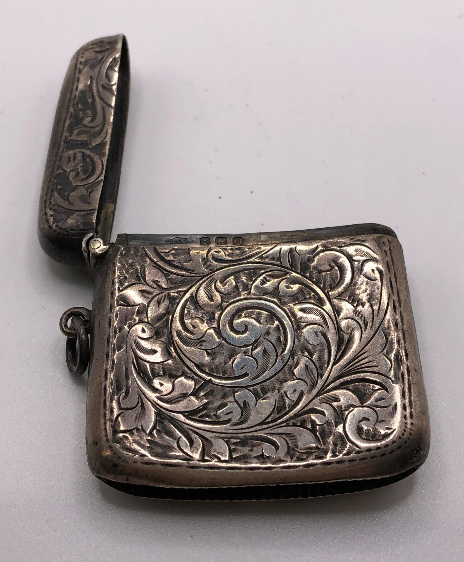 A silver hallmark large vesta case/matchbox striker with floral ...