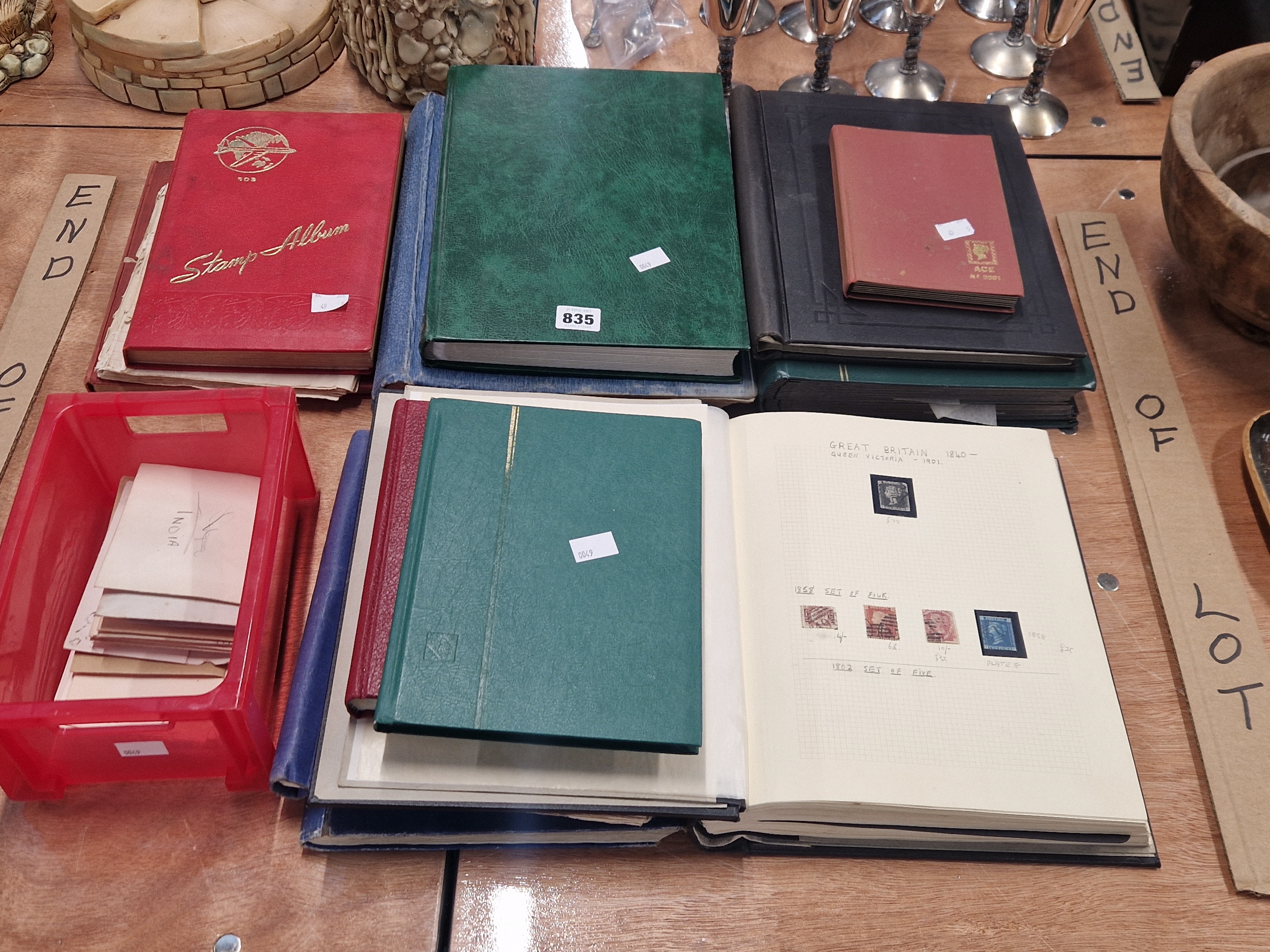 A collection of stamp albums together with loose stamps in envelopes