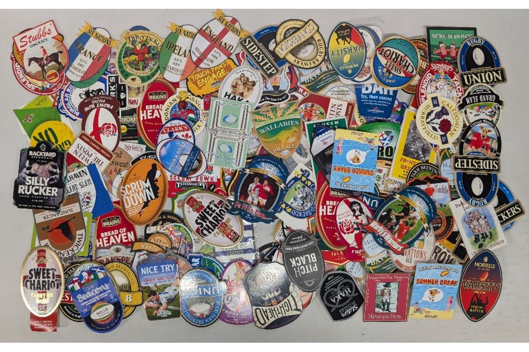 A large collection of Beer Pump Clip Labels, most with rugby themed ...