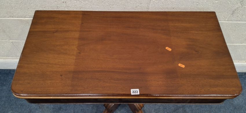 A REGENCY MAHOGANY TEA TABLE, with a rotating fold-over top, raised on ...