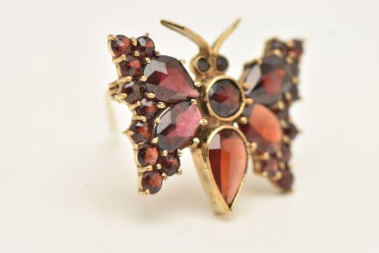 A 9CT YELLOW GOLD GARNET BUTTERFLY BROOCH, round, oval and pear cut ...