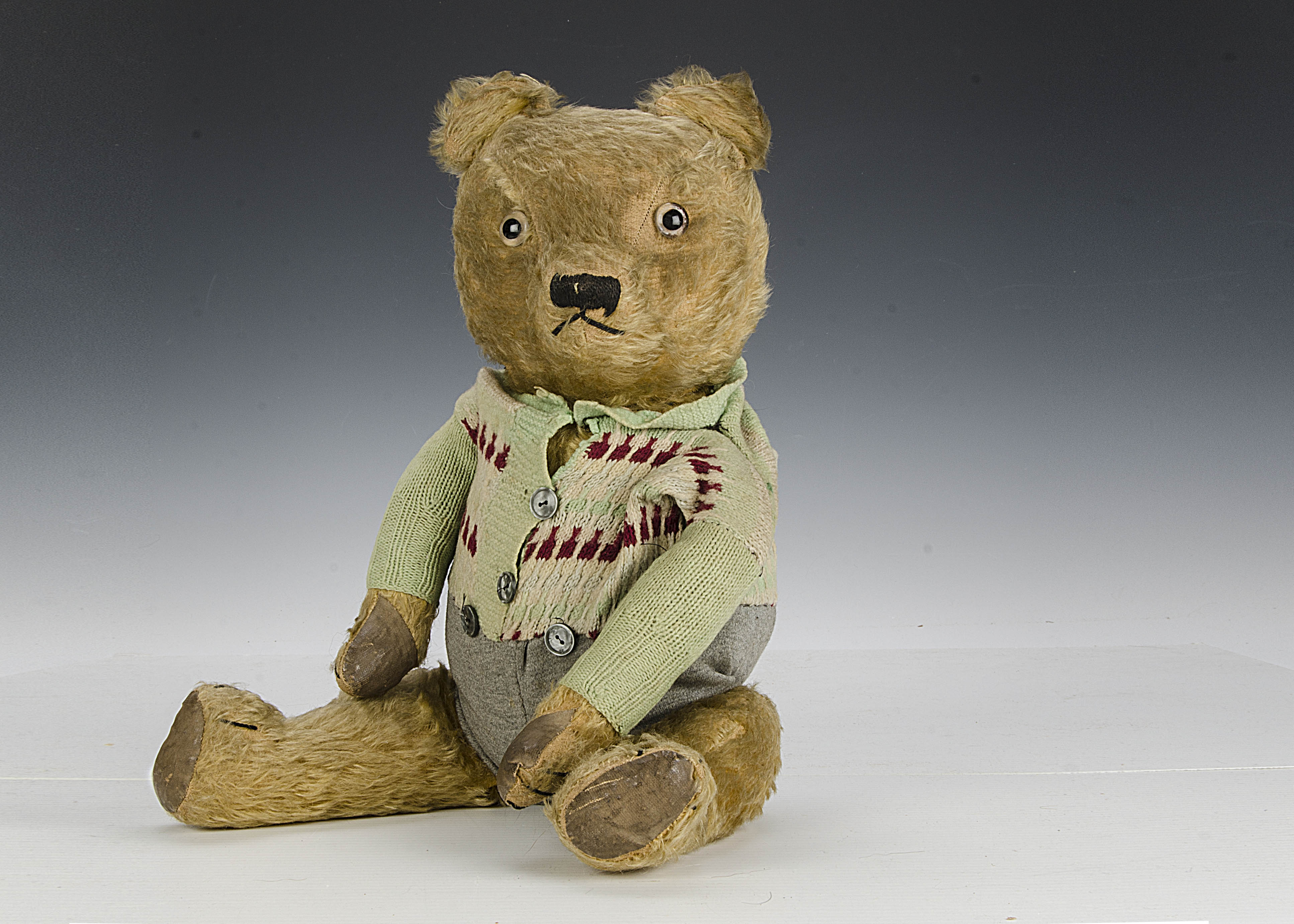 A 1940s British teddy bear, with golden mohair, clear and black glass ...