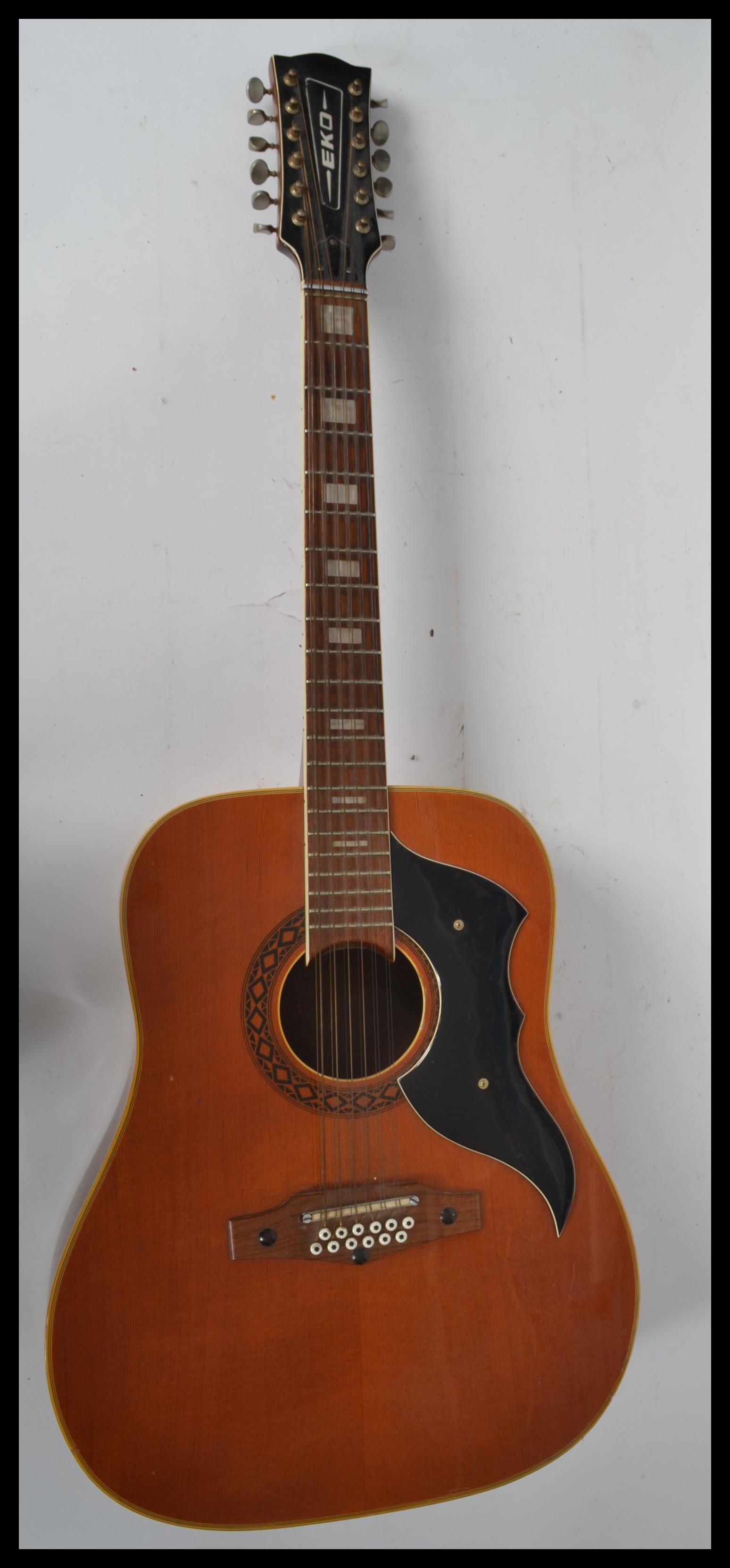 A vintage Eko made 12 string acoustic guitar. The headstock with Eko ...