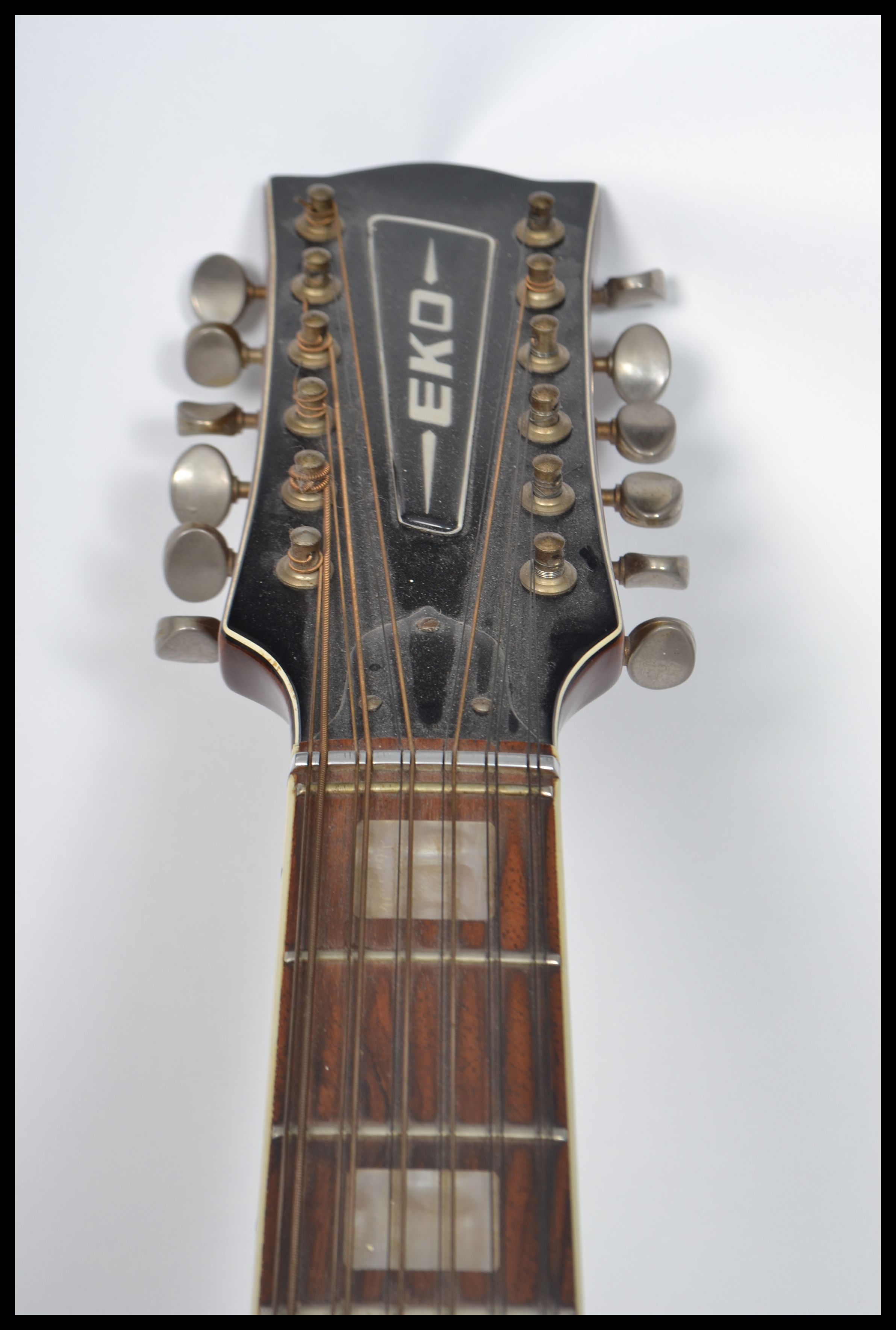 A vintage Eko made 12 string acoustic guitar. The headstock with Eko ...