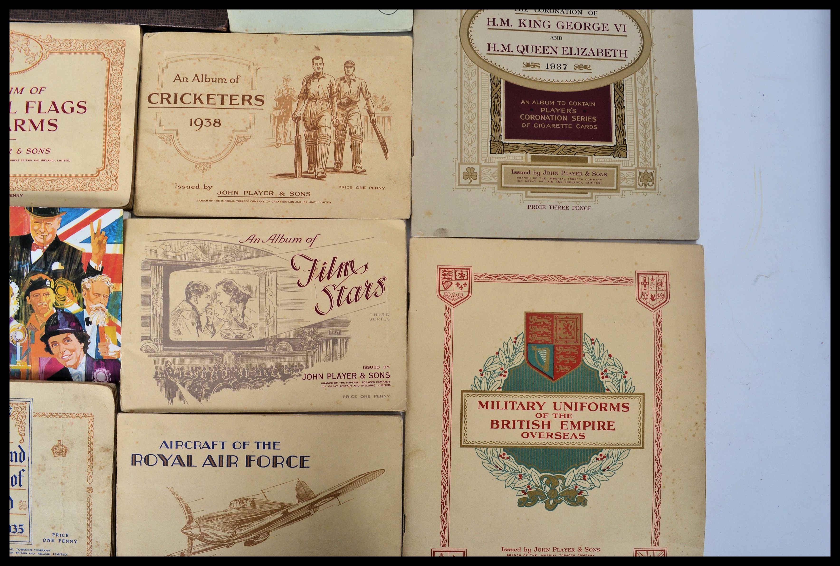 A collection of vintage 20th century cigarette cards. Mostly held ...
