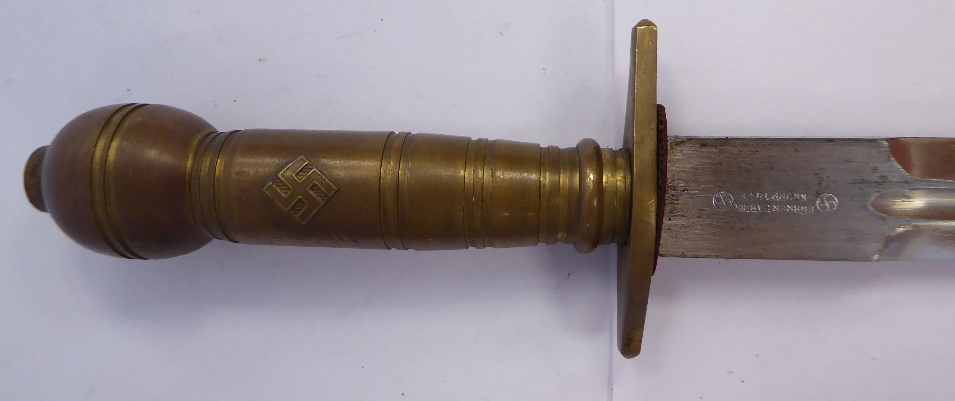 A German military dagger with a brass handle, pommel and hilt and ...