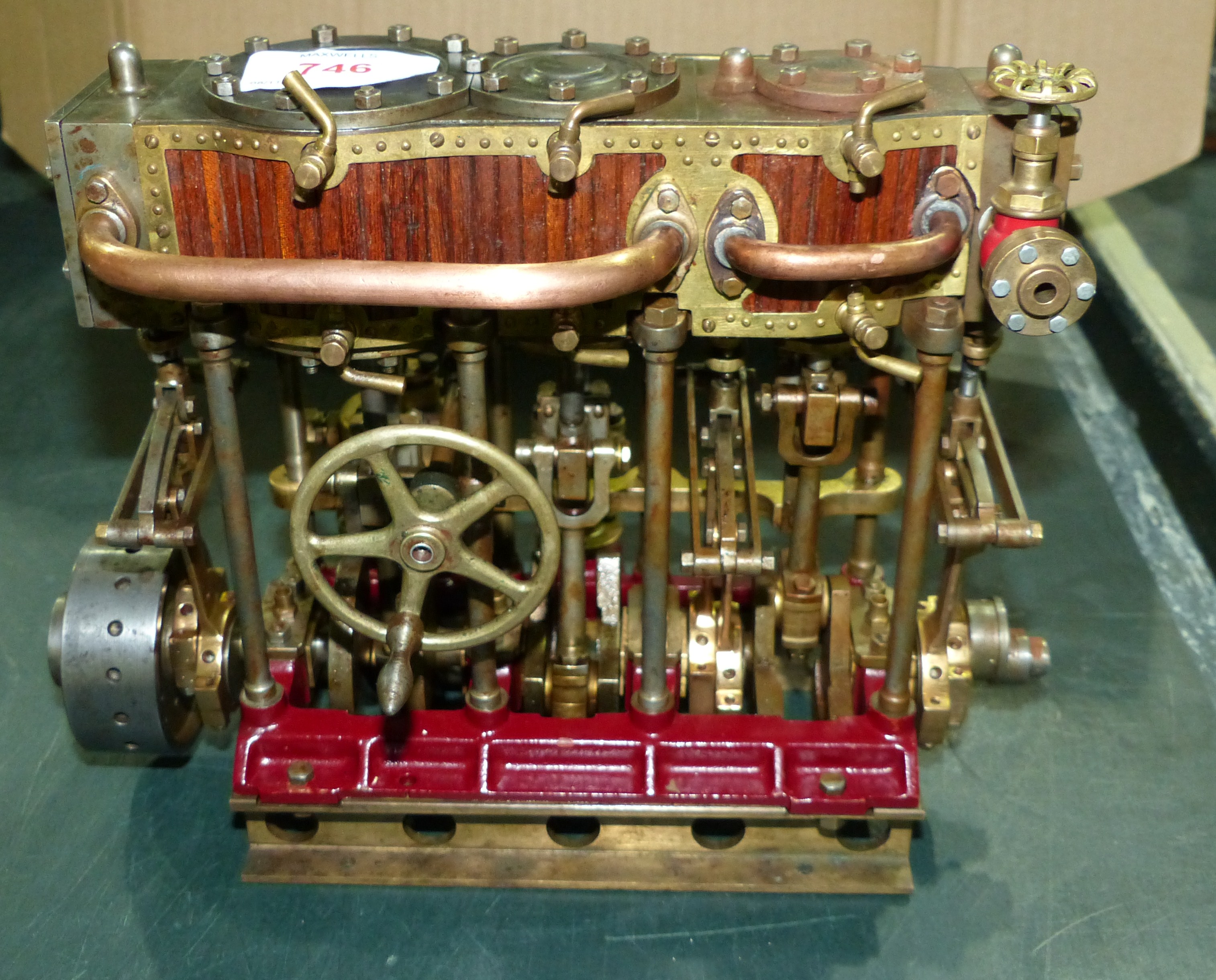 A scale model steam driven triple cylinder marine reciprocating engine