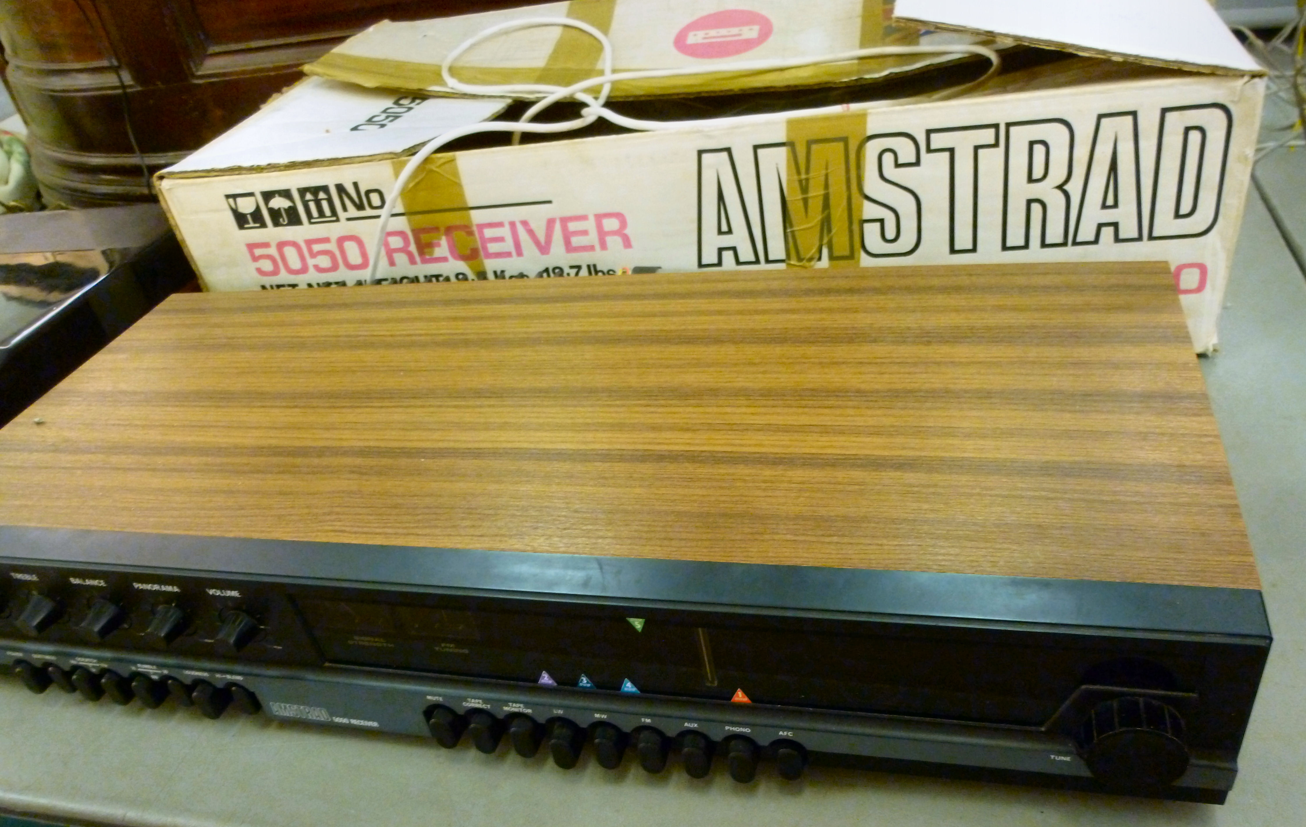 An Amstrad 5050 stereo receiver, in a teak finished case 26''w boxed F