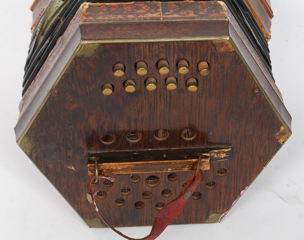 A vintage wooden squeeze box accordion instrument with central bellows ...