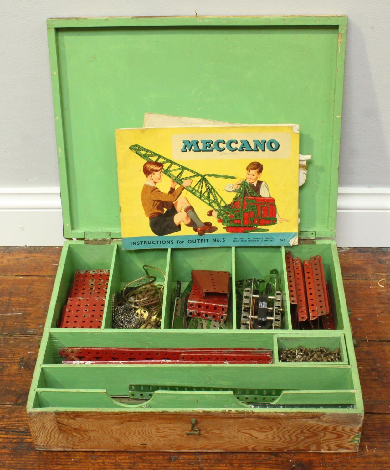A compartmented wooden box of assorted Meccano including bolts, cogs ...