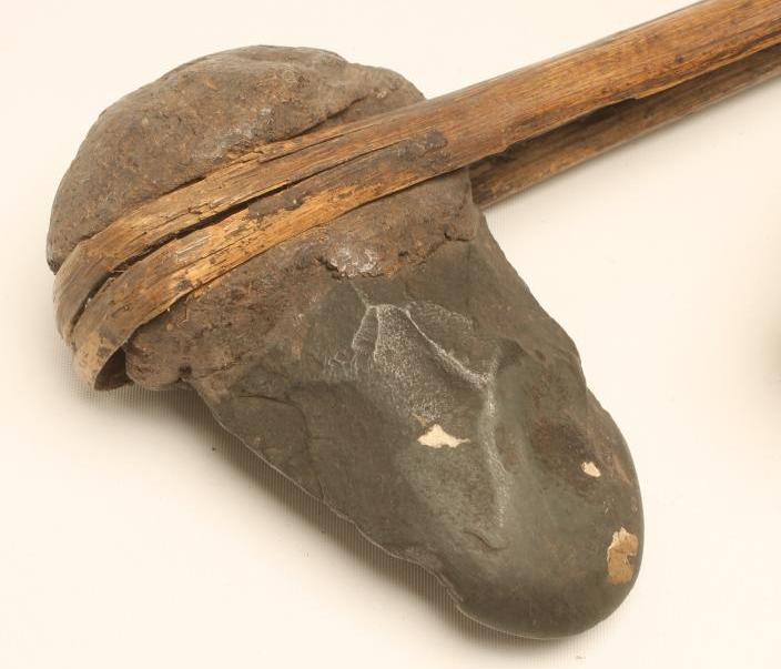 TWO ABORIGINAL STONE AXES, with shaped axe heads and resin fixing it to ...