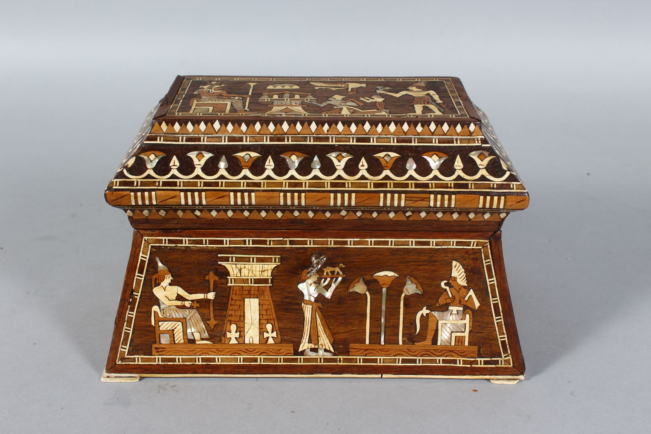 AN EGYPTIAN REVIVAL SARCOPHAGUS SHAPED CASKET, with inlaid decoration ...