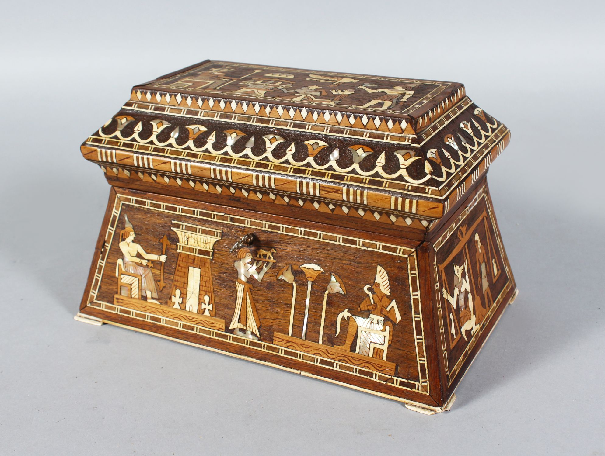 AN EGYPTIAN REVIVAL SARCOPHAGUS SHAPED CASKET, with inlaid decoration ...