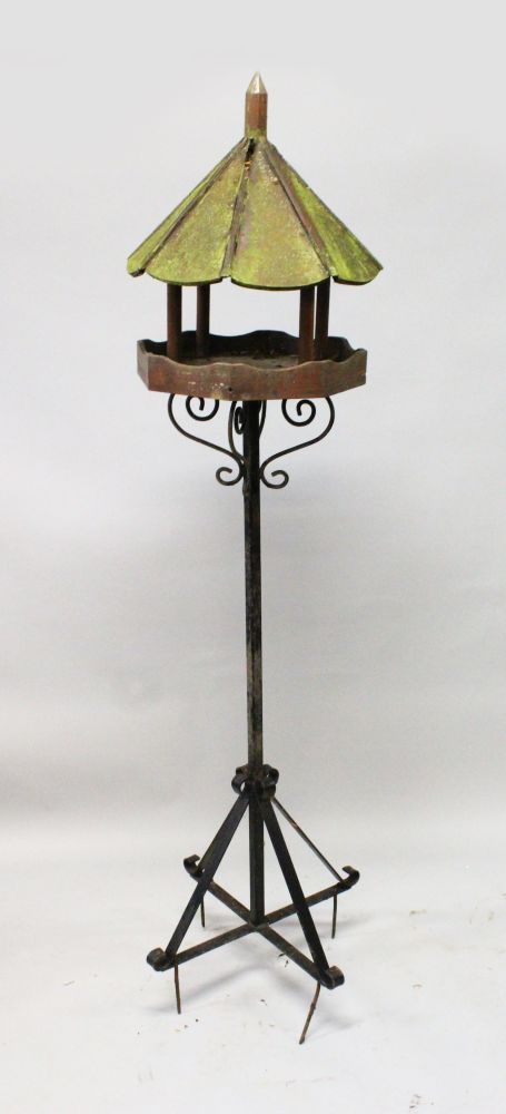 A WROUGHT IRON AND WOODEN BIRD TABLE. 6ft high.