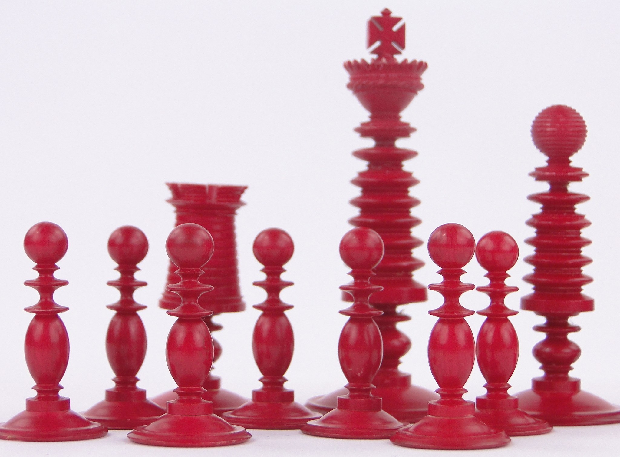 A Victorian red and white stained ivory chess set,by Fisher, 188 Strand ...
