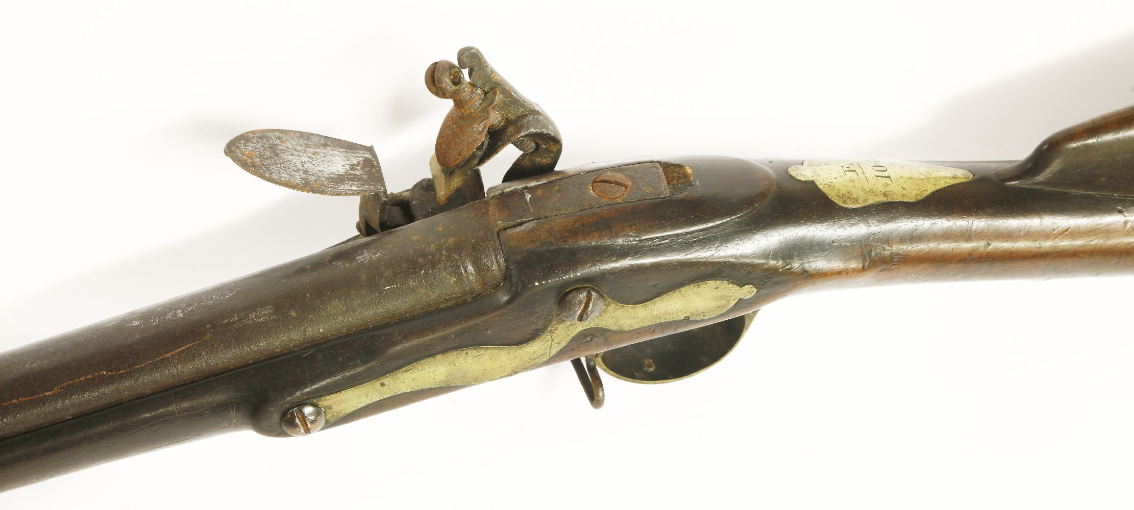 A 'Brown Bess' flintlock musket, with a brass escutcheon, stamped with ...