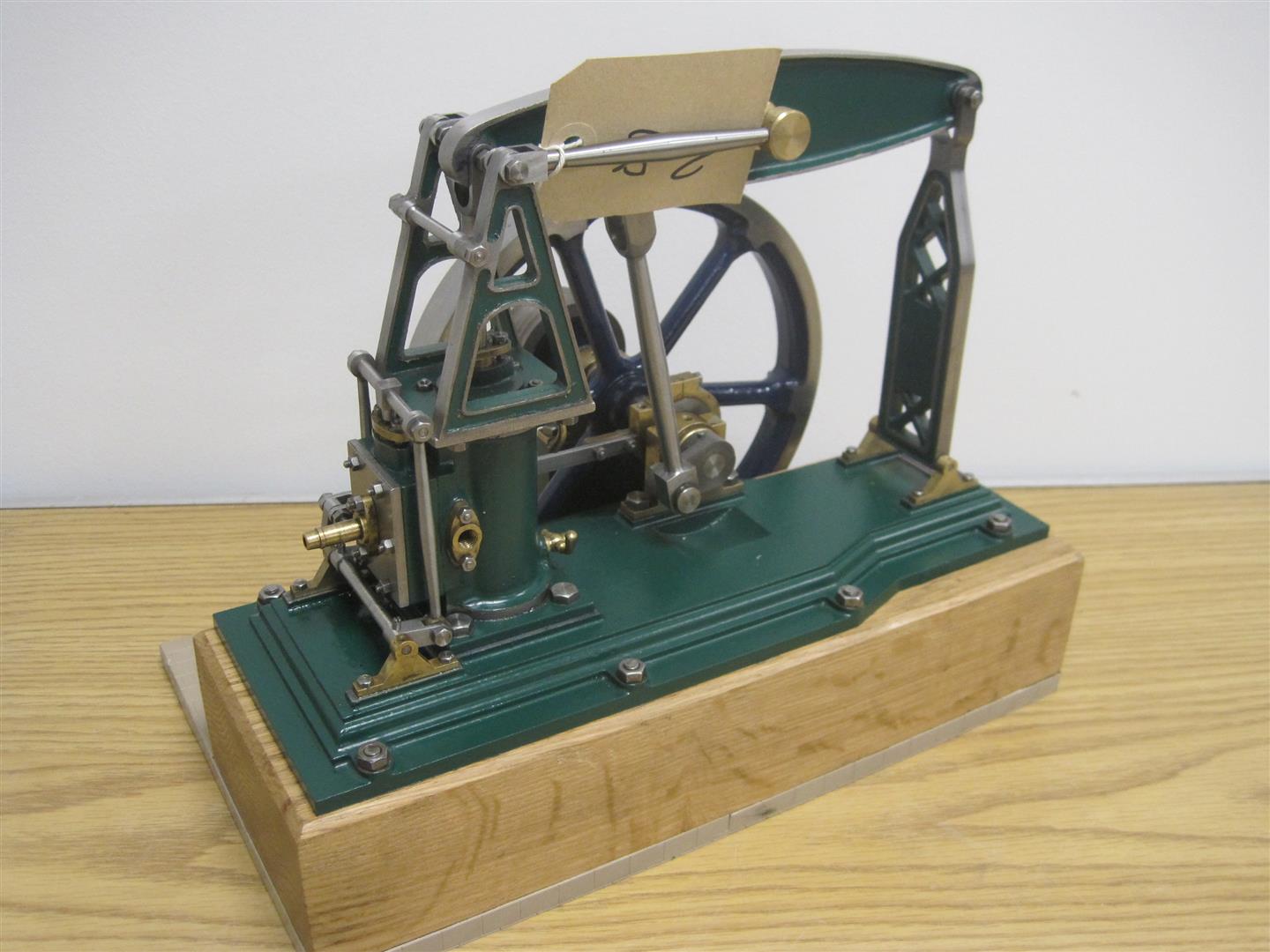 Stuart half beam engine mounted to an oak plinth