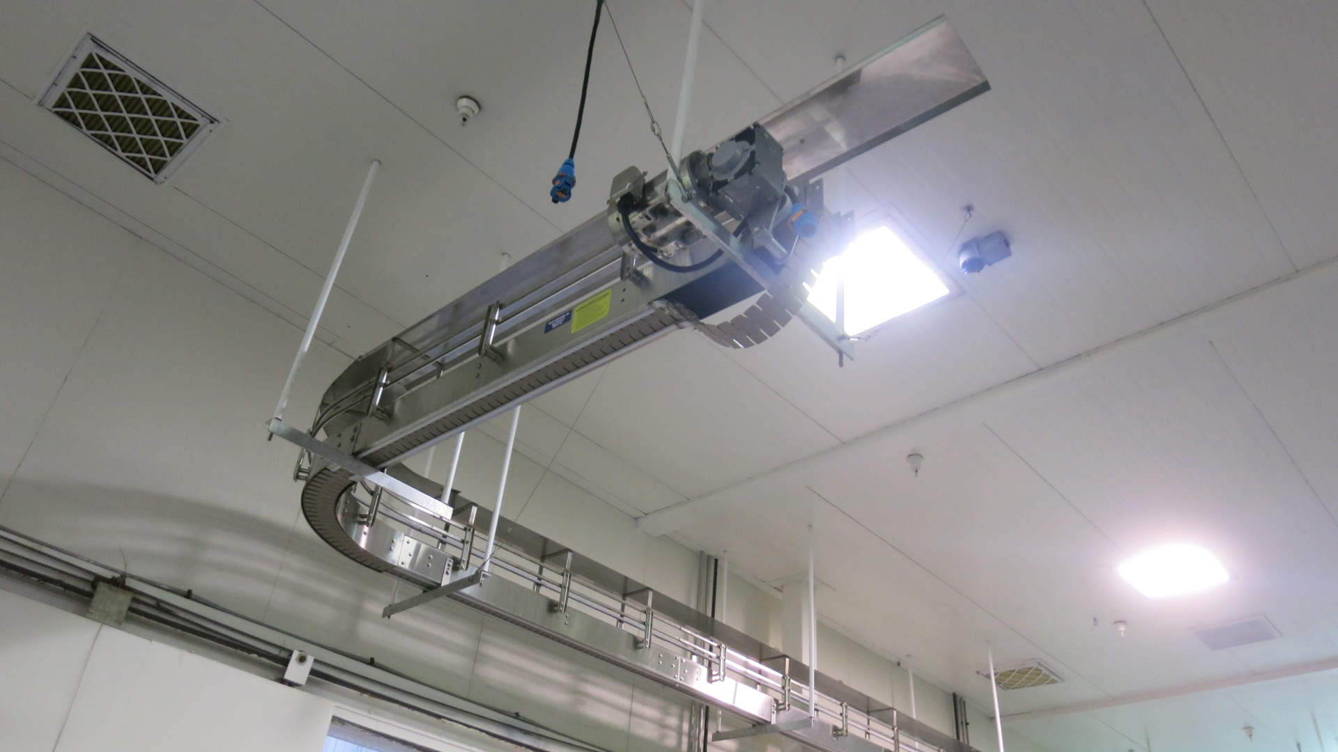 Stainless ceiling suspended feed conveyor, approx 70' total length x 7. ...