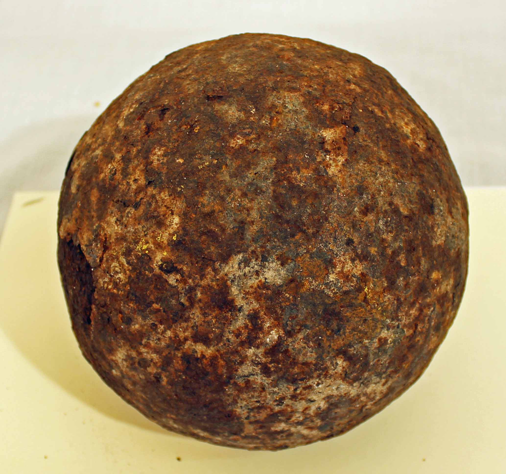 An 18th century cast iron cannon ball approximately 6.5 inches diameter ...