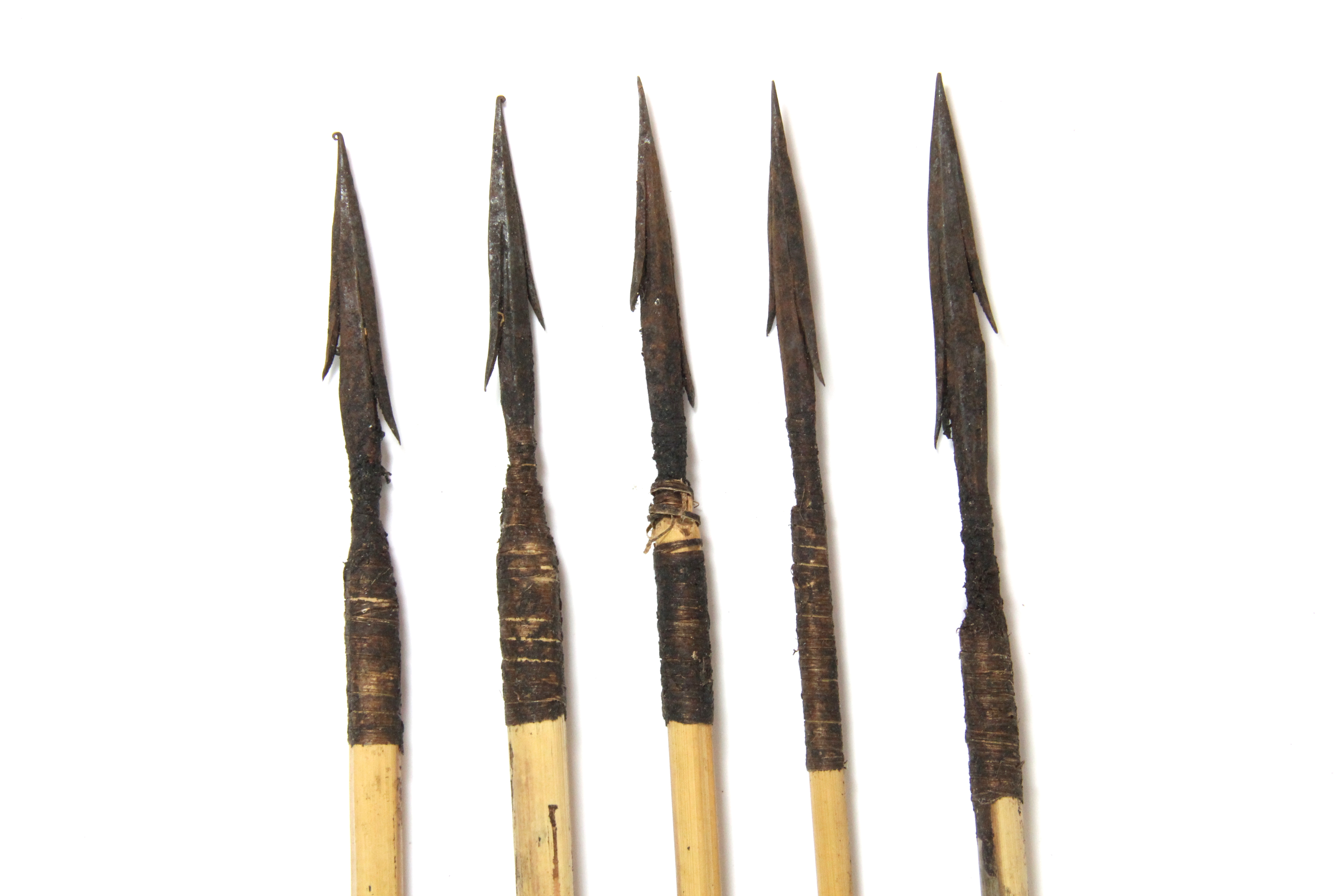 A group of five barbed bamboo and steel tribal arrows and quiver.